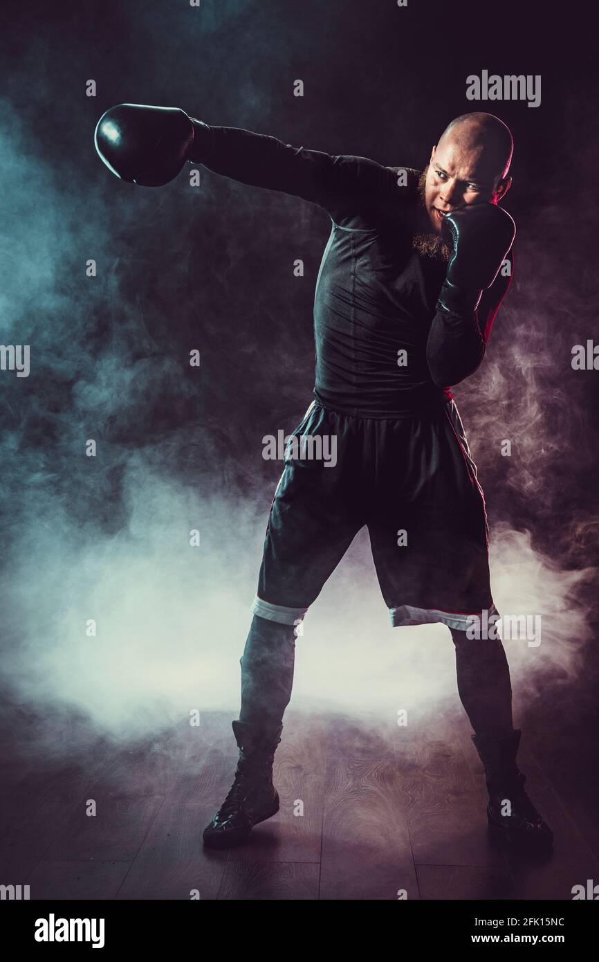 Sportsman boxer fighting on black background with smoke. Boxing Stock ...
