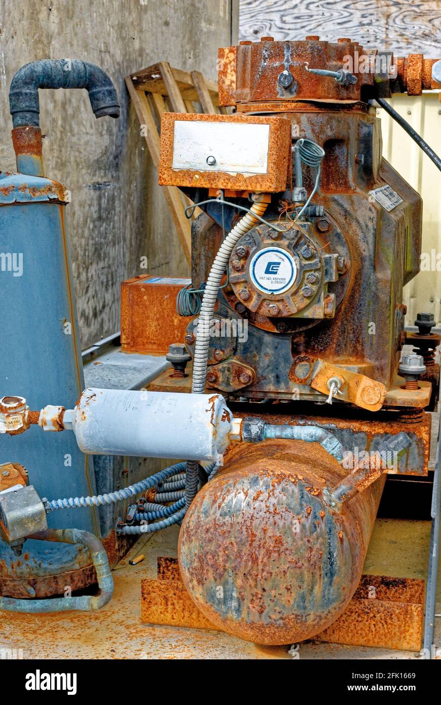 Old rusty discarded air compressor powered by electric motor - Astoria ...