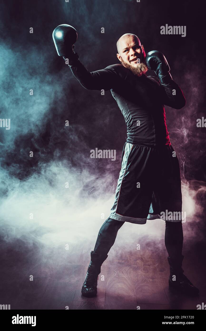 Sportsman boxer fighting on black background with smoke. Boxing Stock ...