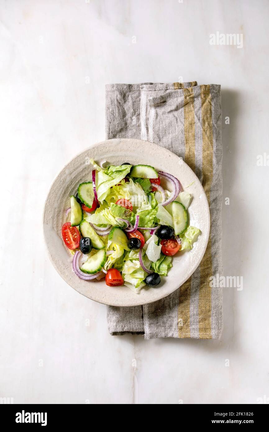 Classic vegetable salad with tomatoes, cucumber, onion, salad leaves ...