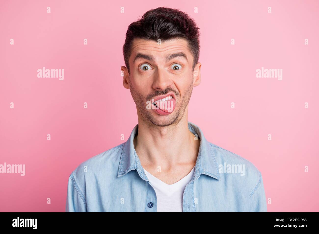 Photo portrait of silly crazy tricky guy showing tongue grimacing ...