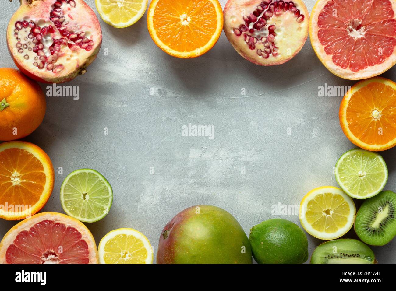 Tropical and exotic colorful fruits in a circle on gray background with ...
