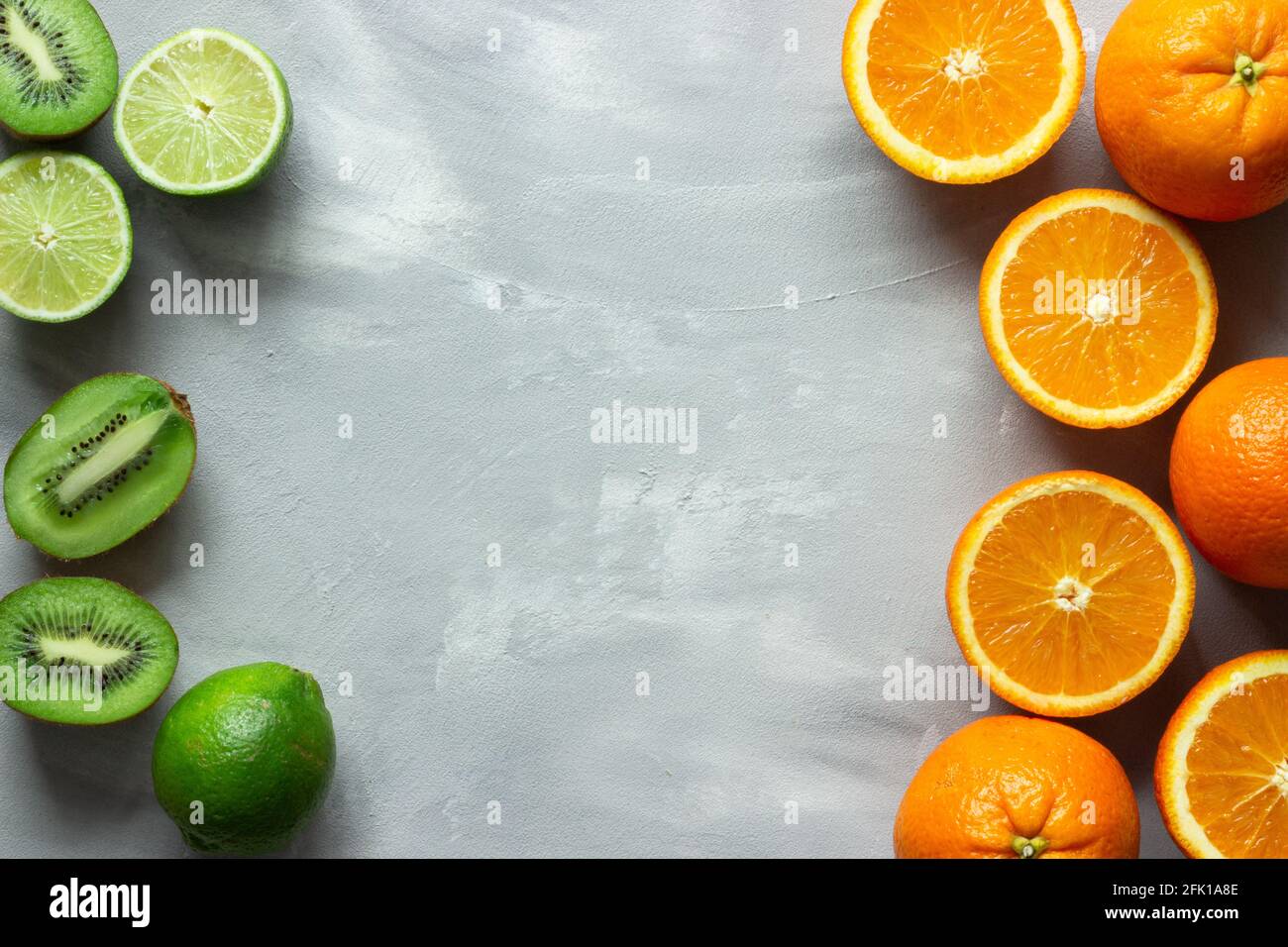 Colorful and tropical citrus fruits on gray background with copy space ...