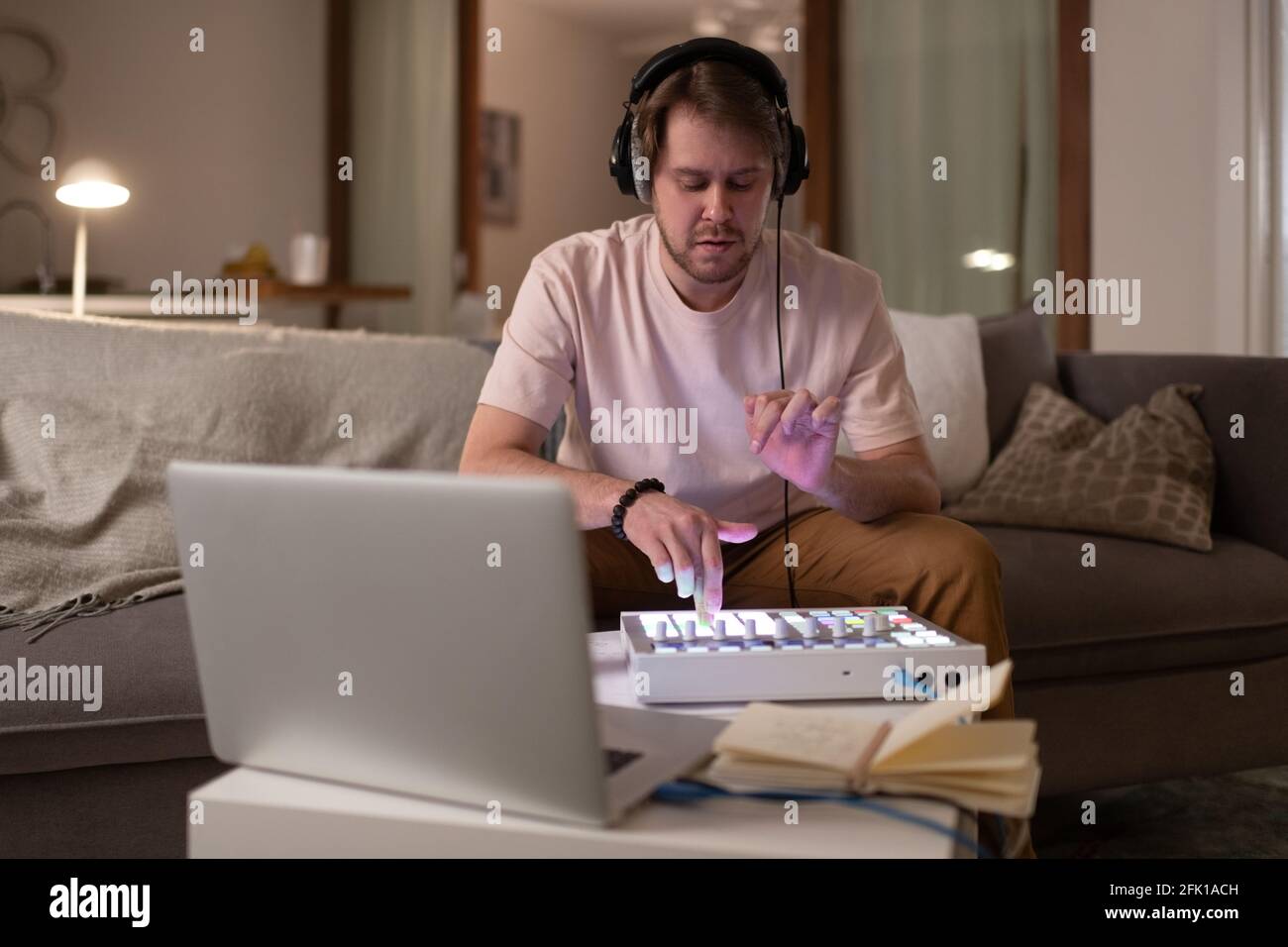 Man using soundboard on couch Stock Photo - Alamy