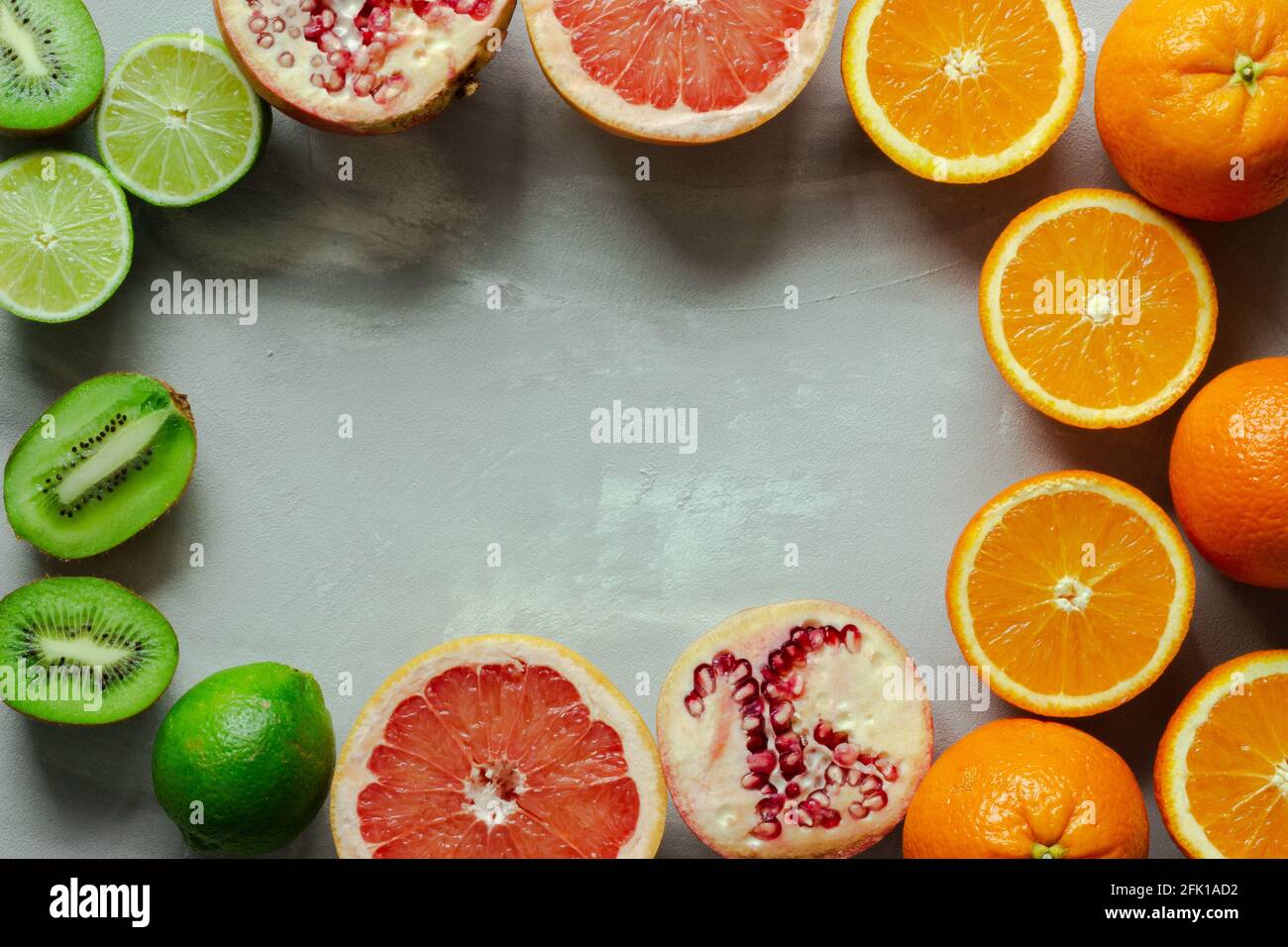 Tropical and exotic colorful fruits in a circle on gray background with ...