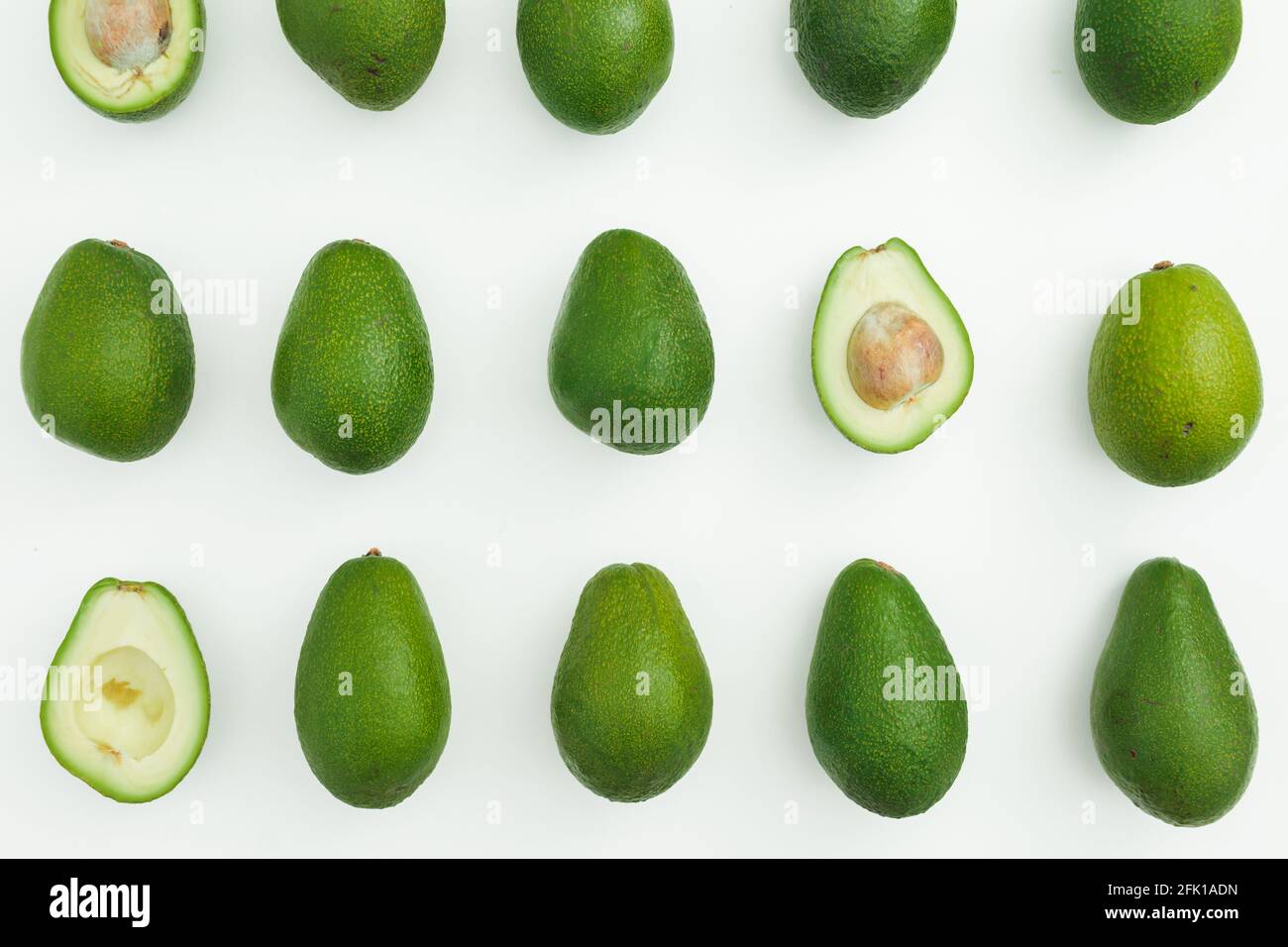 Avocado whole and half pattern on white background. Flat lay, top view ...