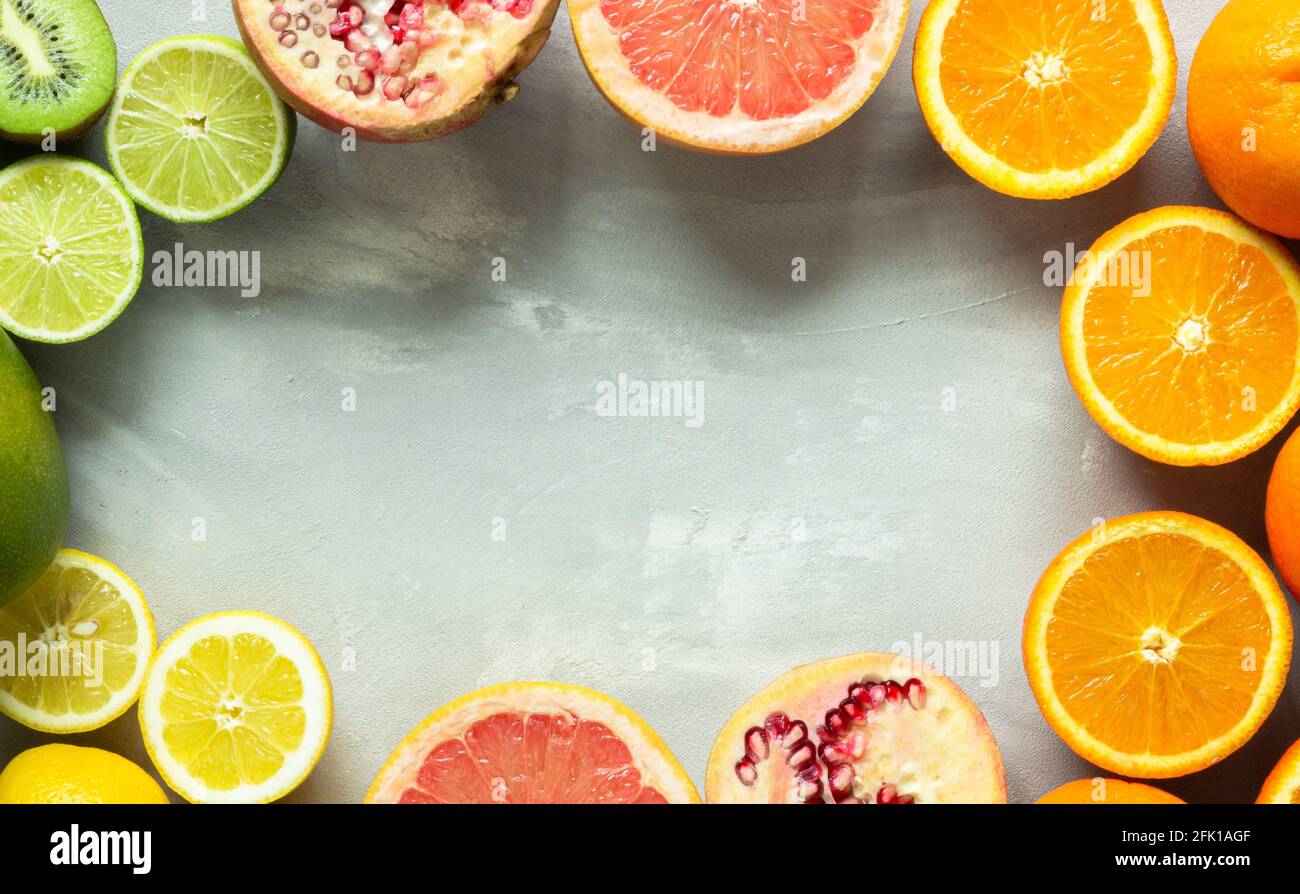 Tropical and exotic colorful fruits in a circle on gray background with ...