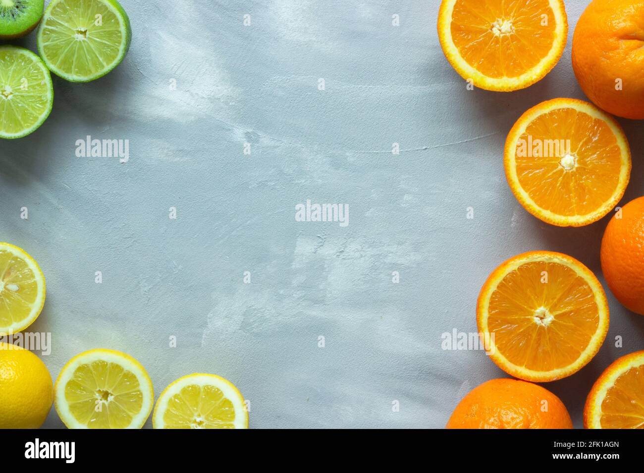 Colorful and tropical citrus fruits on gray background with copy space ...