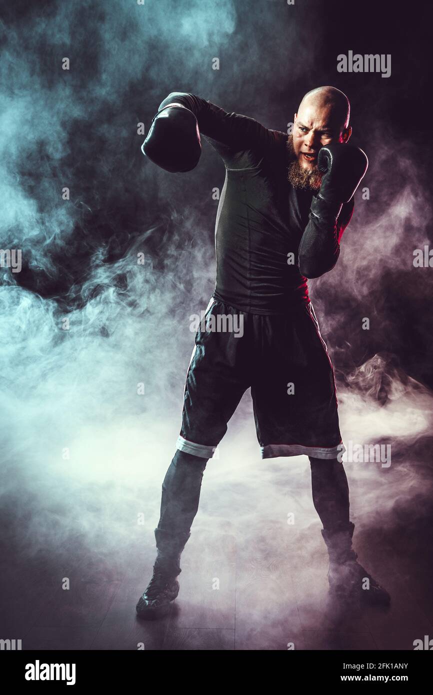 Sportsman boxer fighting on black background with smoke. Boxing Stock ...