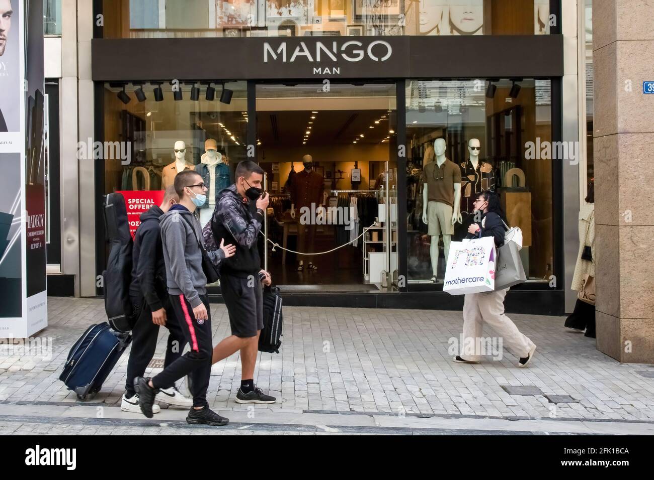 People seen walking past a Mango store at Ermou street close to ...