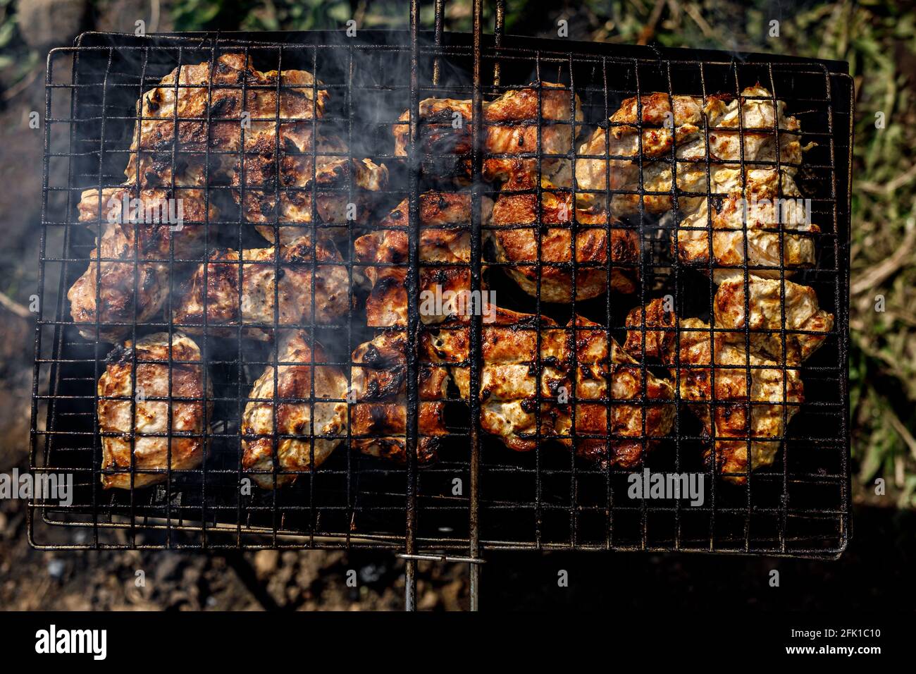 Meat is fried on the grill. The wire rack with roasted pork Stock Photo ...