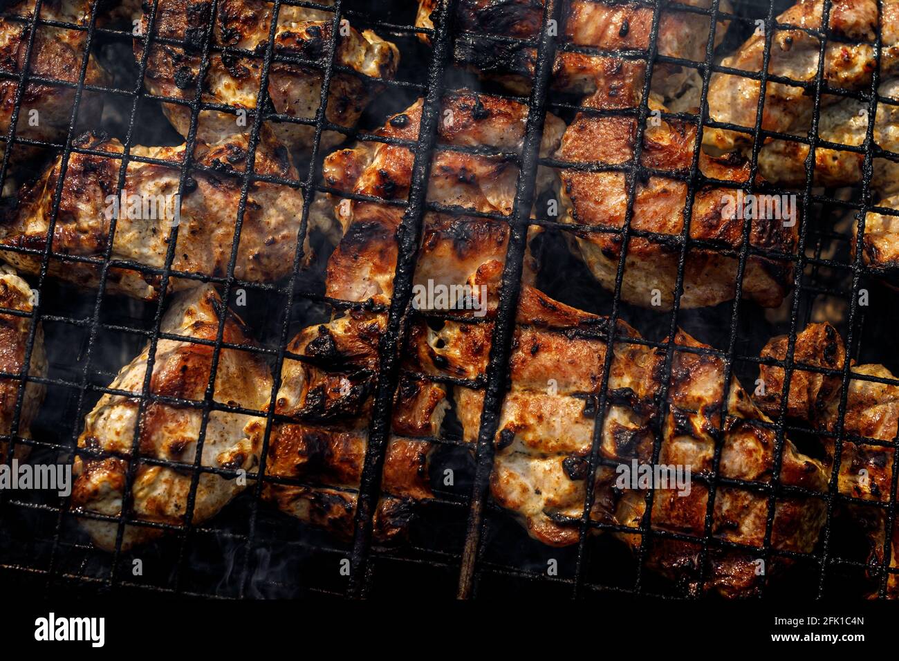 Meat is fried on the grill. The wire rack with roasted pork Stock Photo ...
