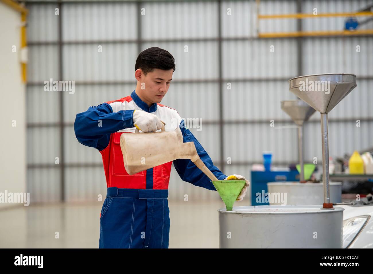 Mechanic pouring oil car hi-res stock photography and images - Alamy