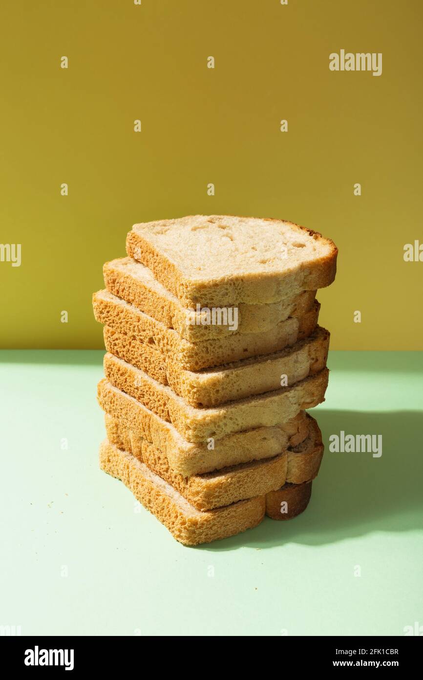 Pile of toast bread on one-ton background in green and yellow Stock ...