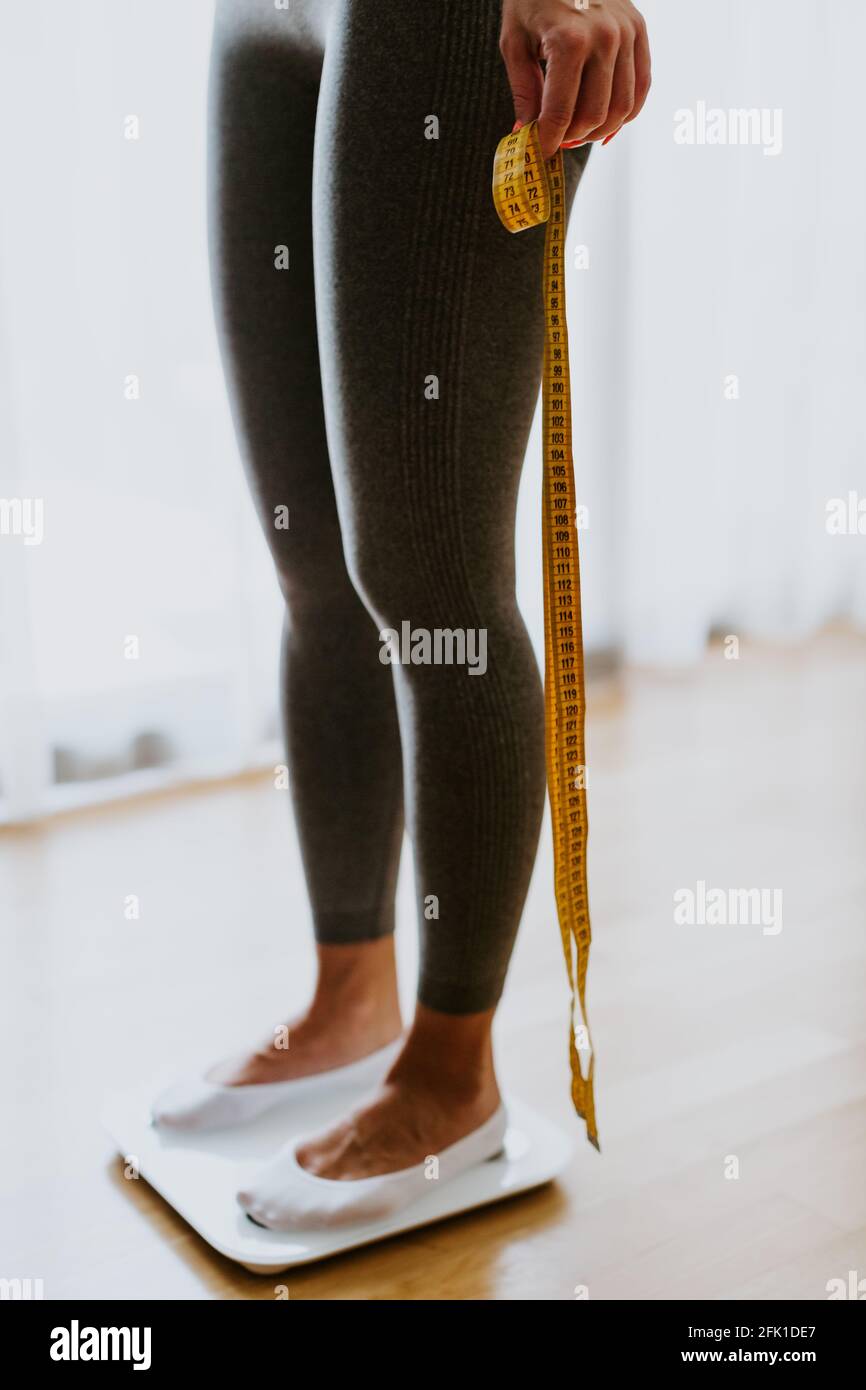 Woman step on Weighing Scale for Measuring Body Weight At Home Stock ...