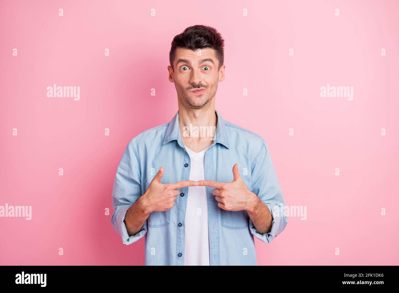 Photo of shy funky young brunette man touch fingers together isolated ...