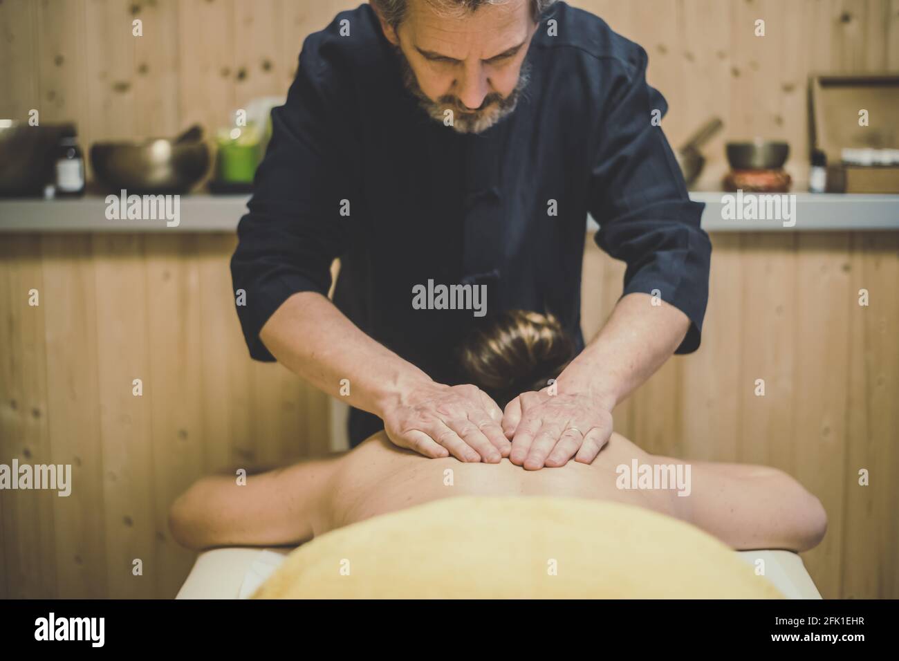 Soft focus view of man massaging a woman in a wellness center Oiled ...