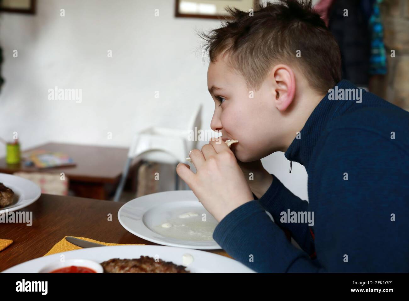 Kid eating cheburek in an asian restaurant Stock Photo - Alamy