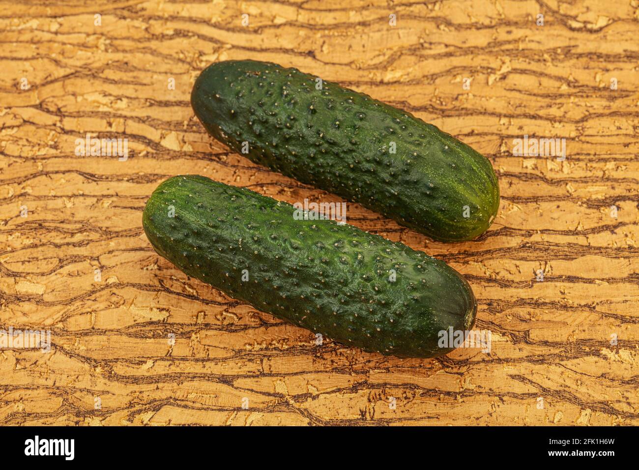 Green fresh two cucumbers over background Stock Photo - Alamy
