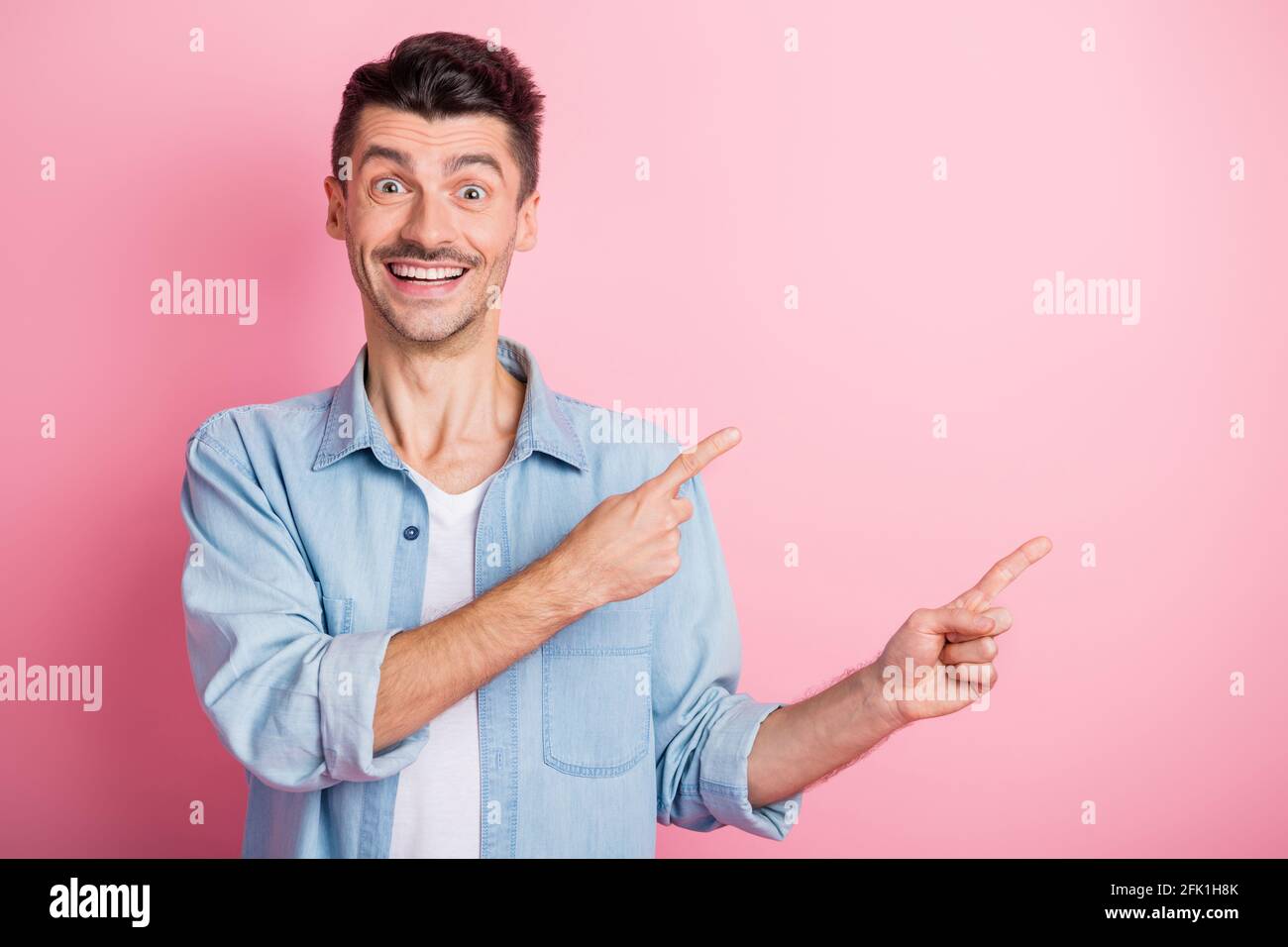 Photo of amazed handsome young brunette man point index finger empty ...