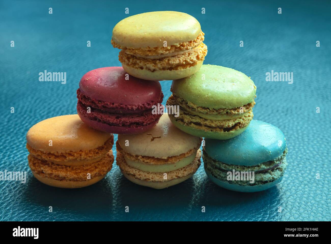 Stacked colorful macaroons with blue background Stock Photo - Alamy