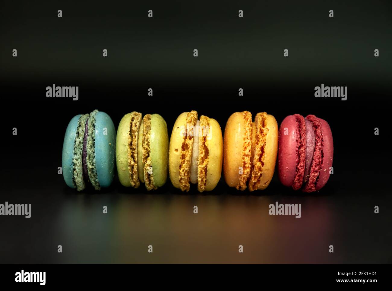 Colorful macaroons against the black background Stock Photo - Alamy