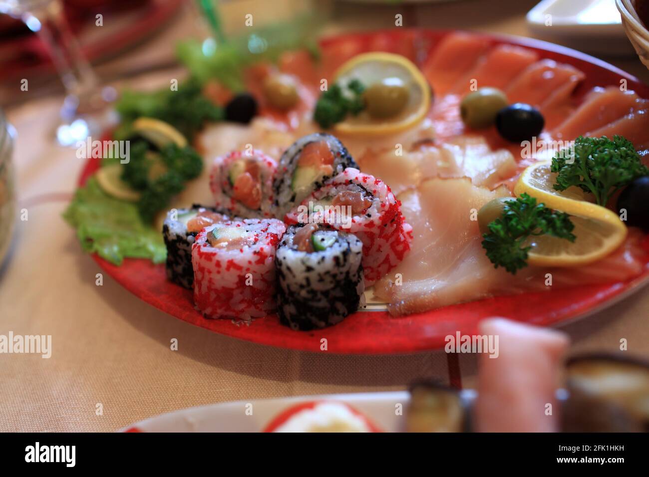 Sushi and sliced fish on a plate in a restaurant Stock Photo - Alamy