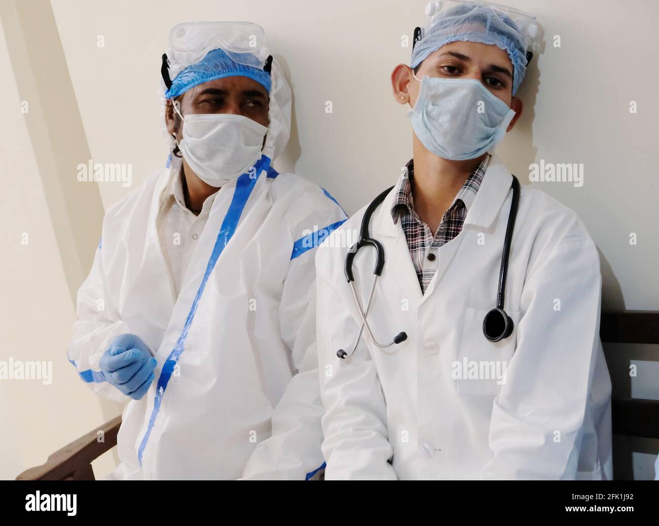 Team of medical workers with protective uniform and equipment in a ...