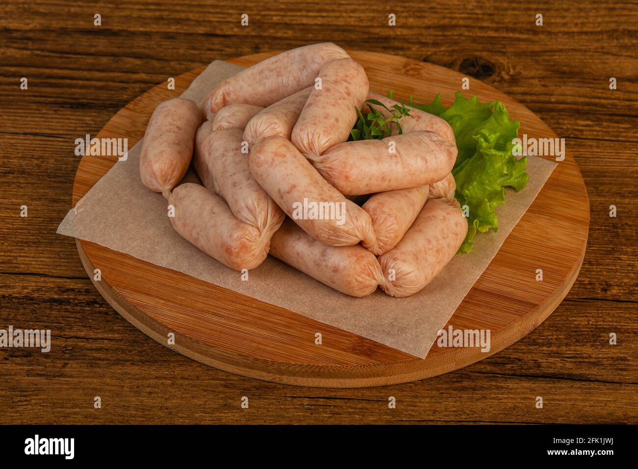 Raw natural chicken baby sausages for roast Stock Photo - Alamy