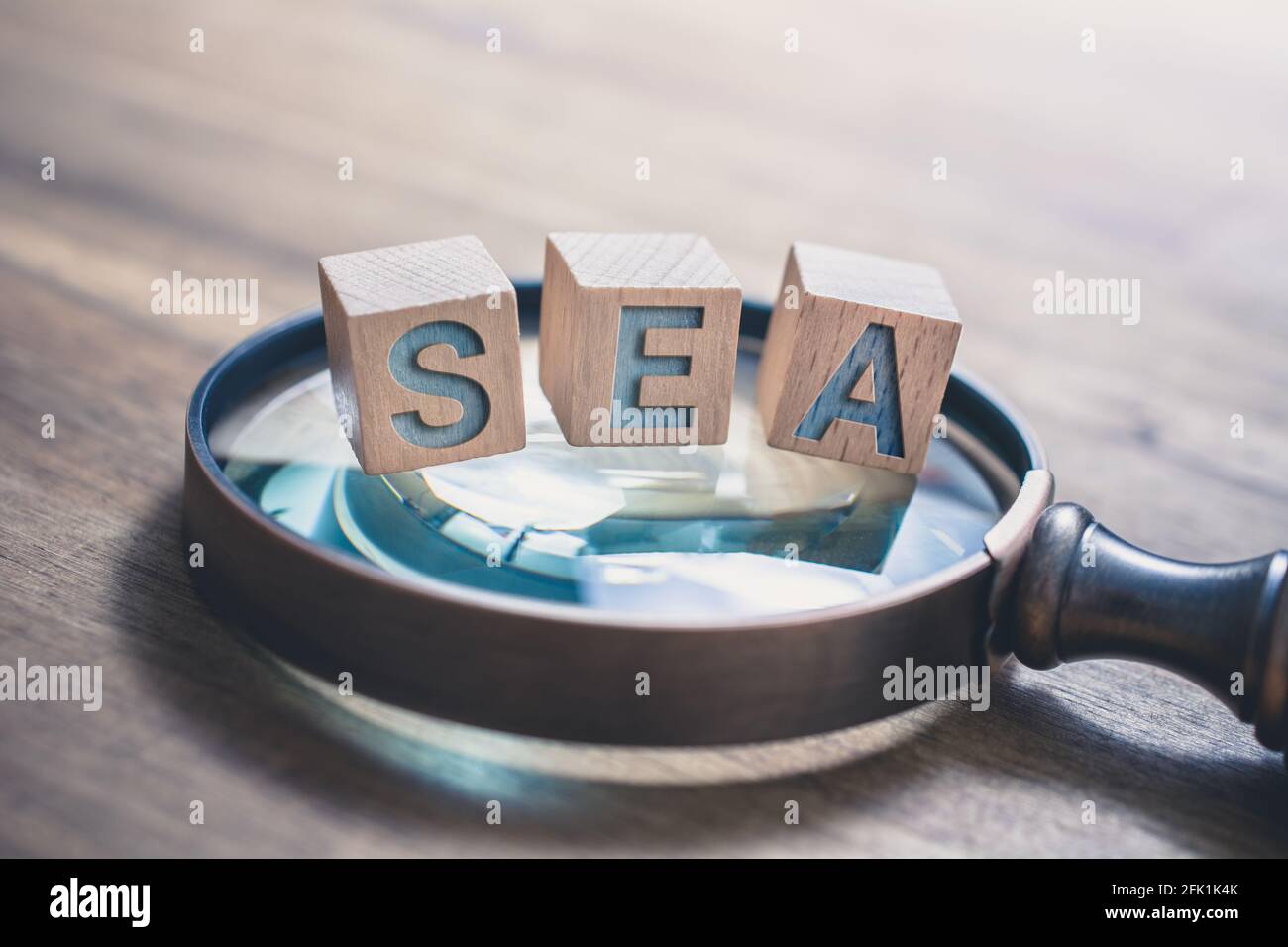 Vintage Magnifier With SEA Blocks On An Old Wooden Table - Search ...