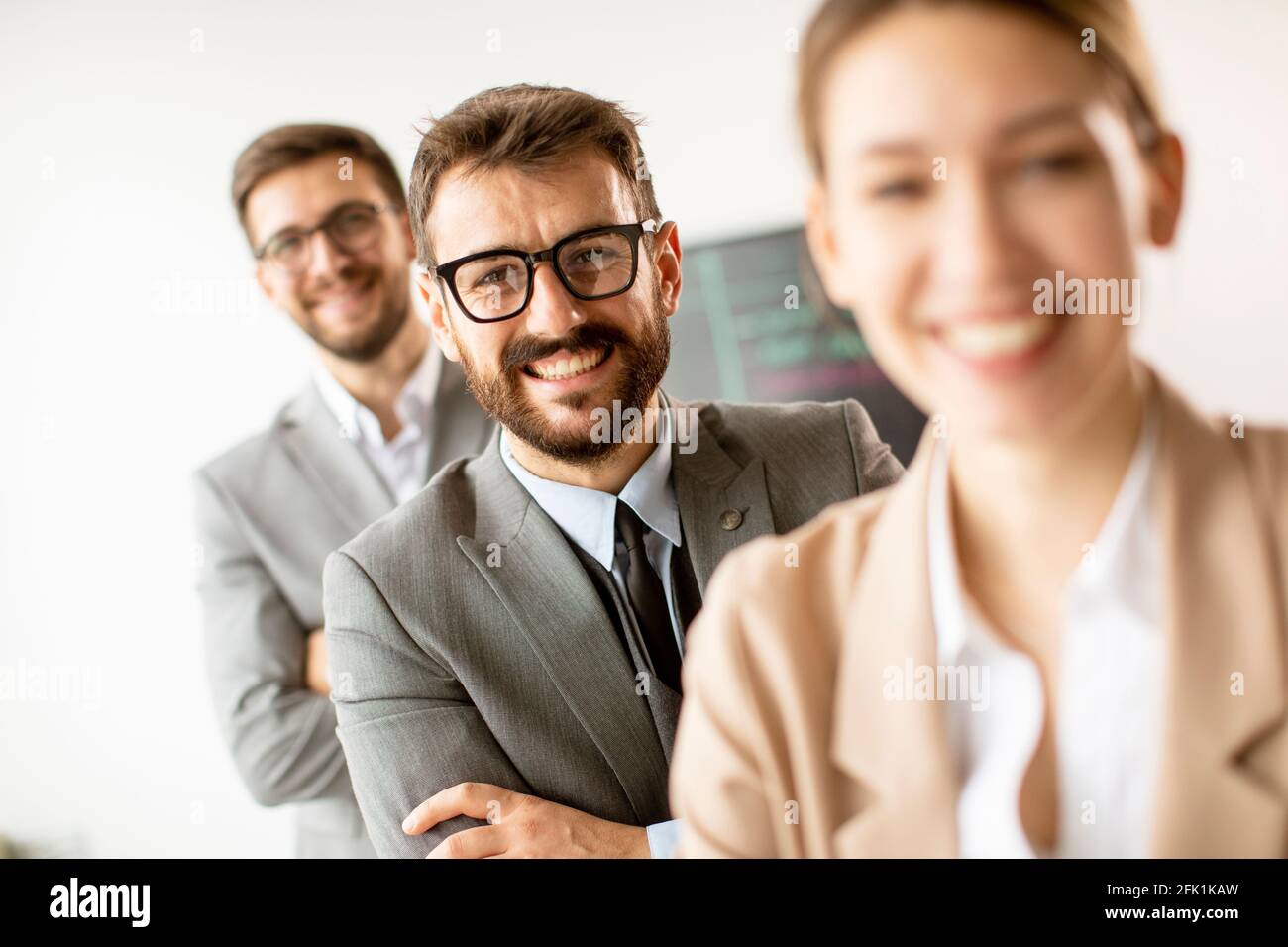 Smiling young business people standing in a row together Stock Photo ...
