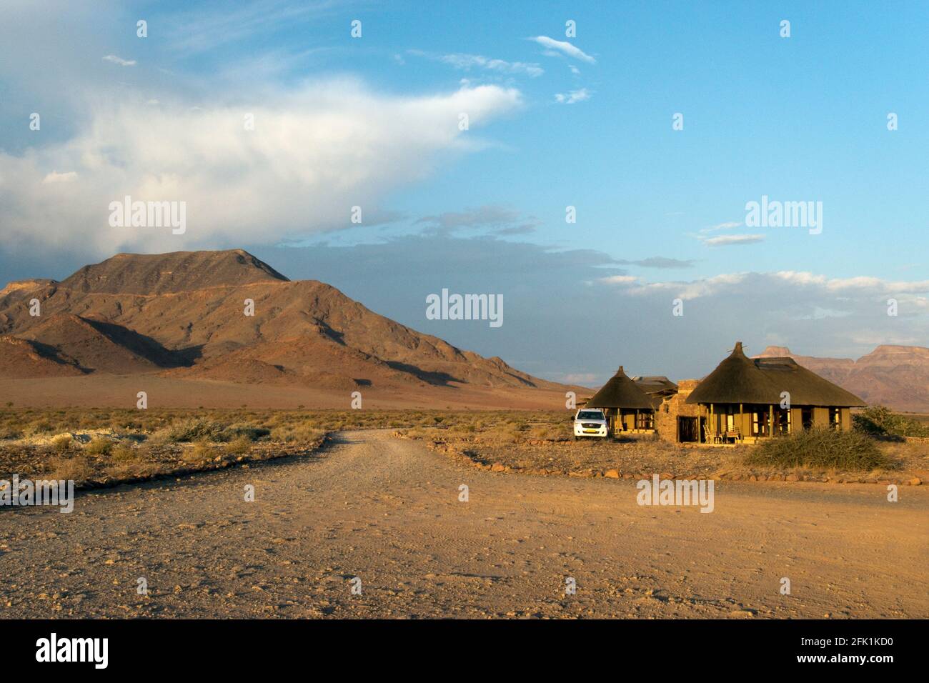 Guest rondavels (chalets) at a lodge in the rugged desert landscape ...