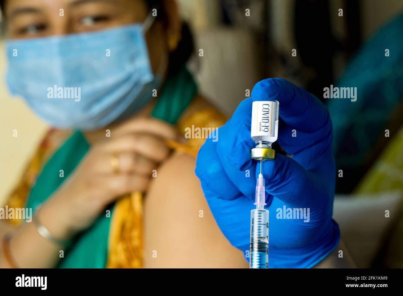 Doctor injecting vaccine into arm of patient Stock Photo - Alamy