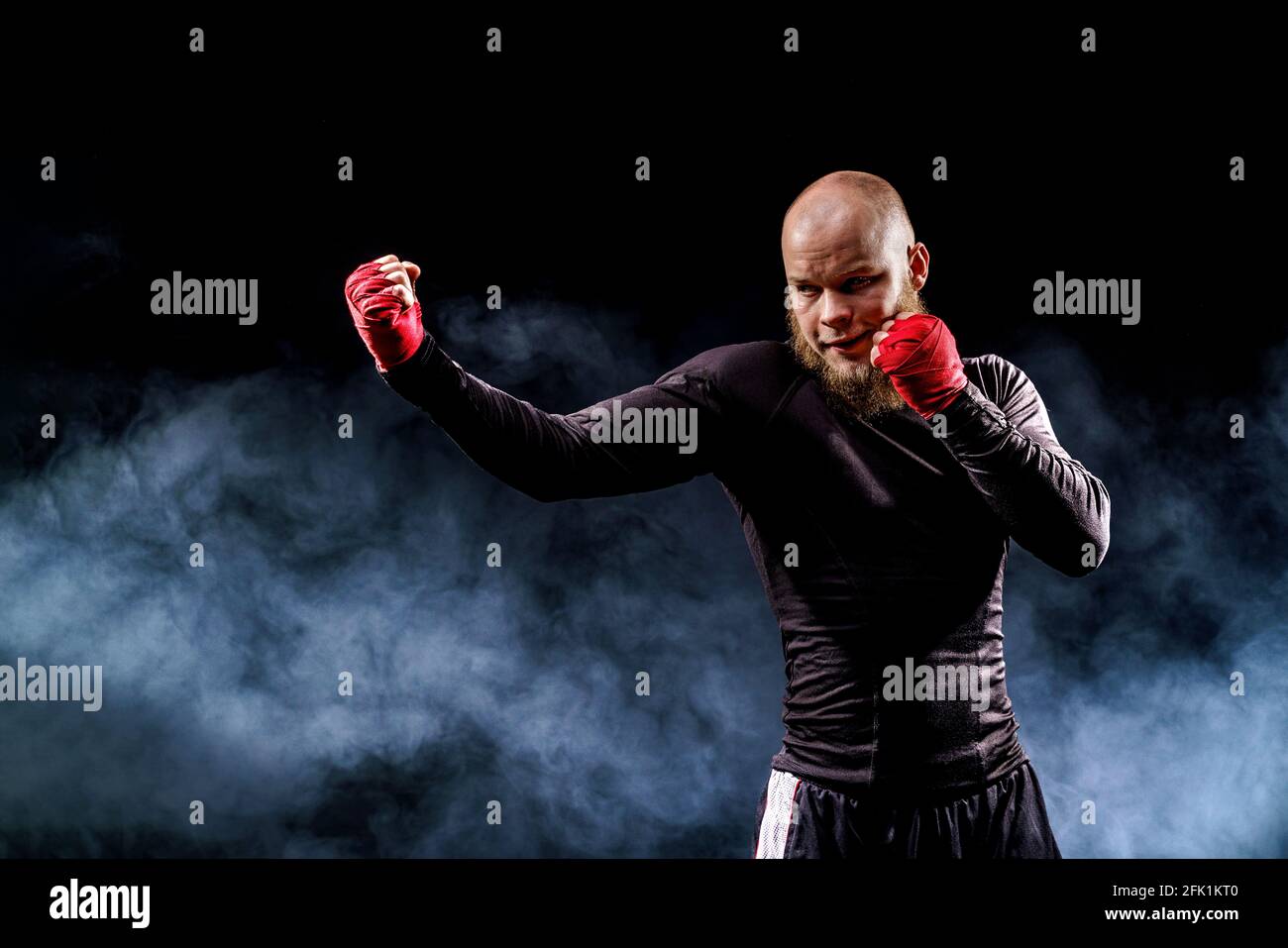 Sportsman boxer fighting on black background with smoke. Boxing Stock ...