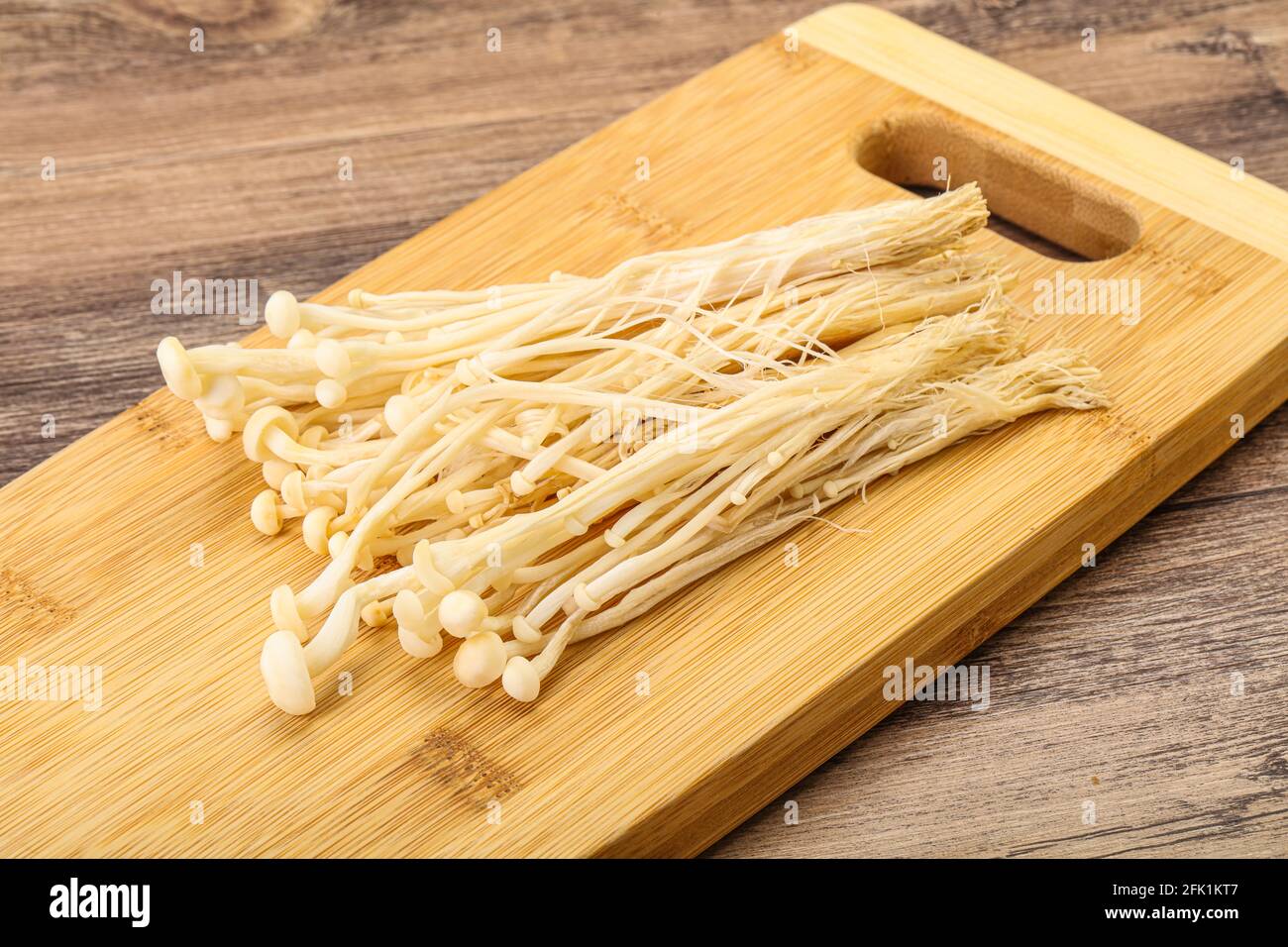 Raw Japanese Enoki mushrooms for cooking Stock Photo - Alamy