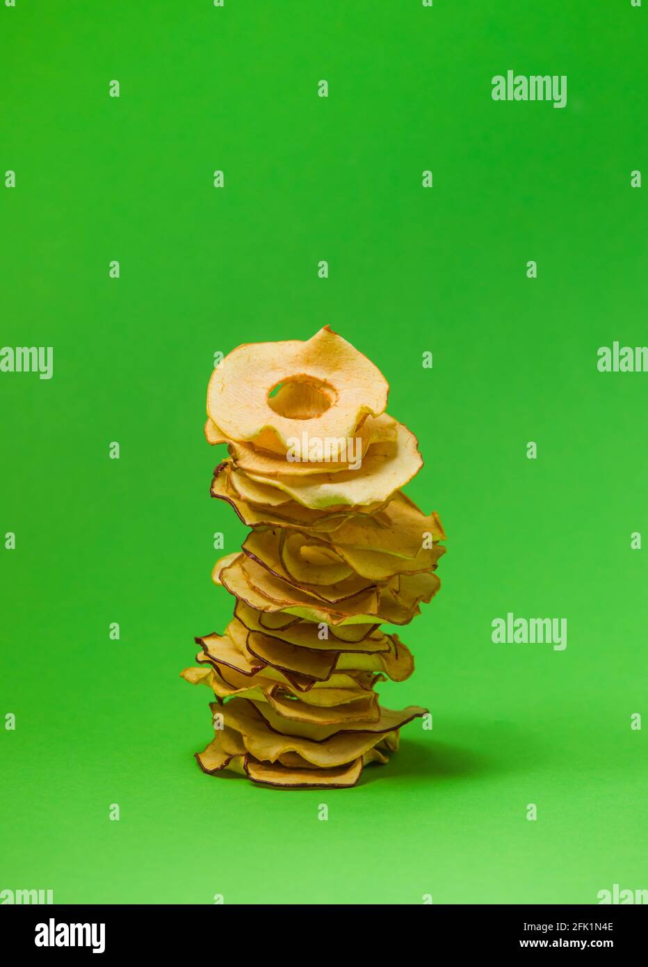 Tower of round dried slices of apple on the green Stock Photo - Alamy
