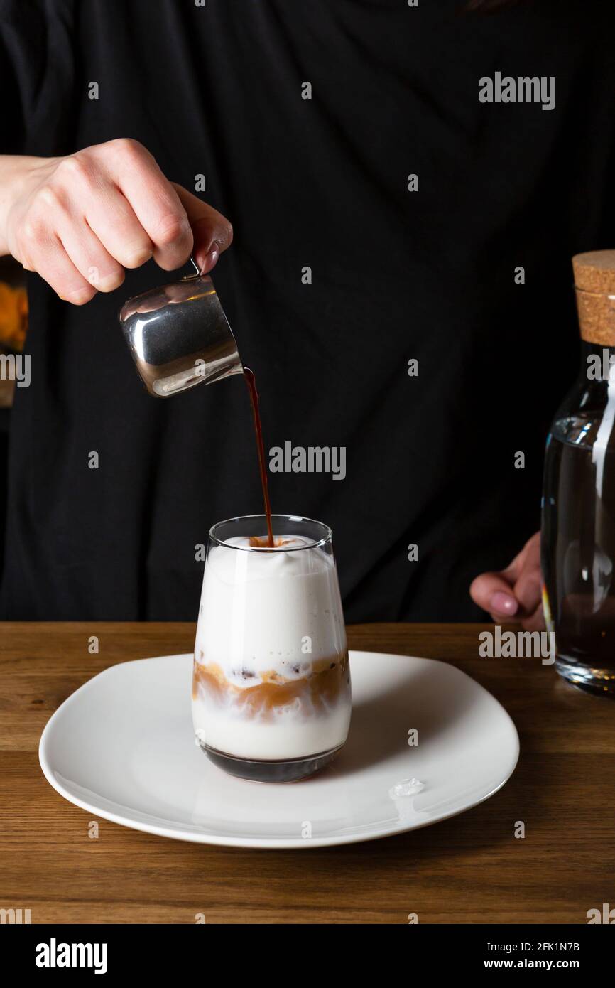 Barista making iced coffee latte, no face Stock Photo - Alamy