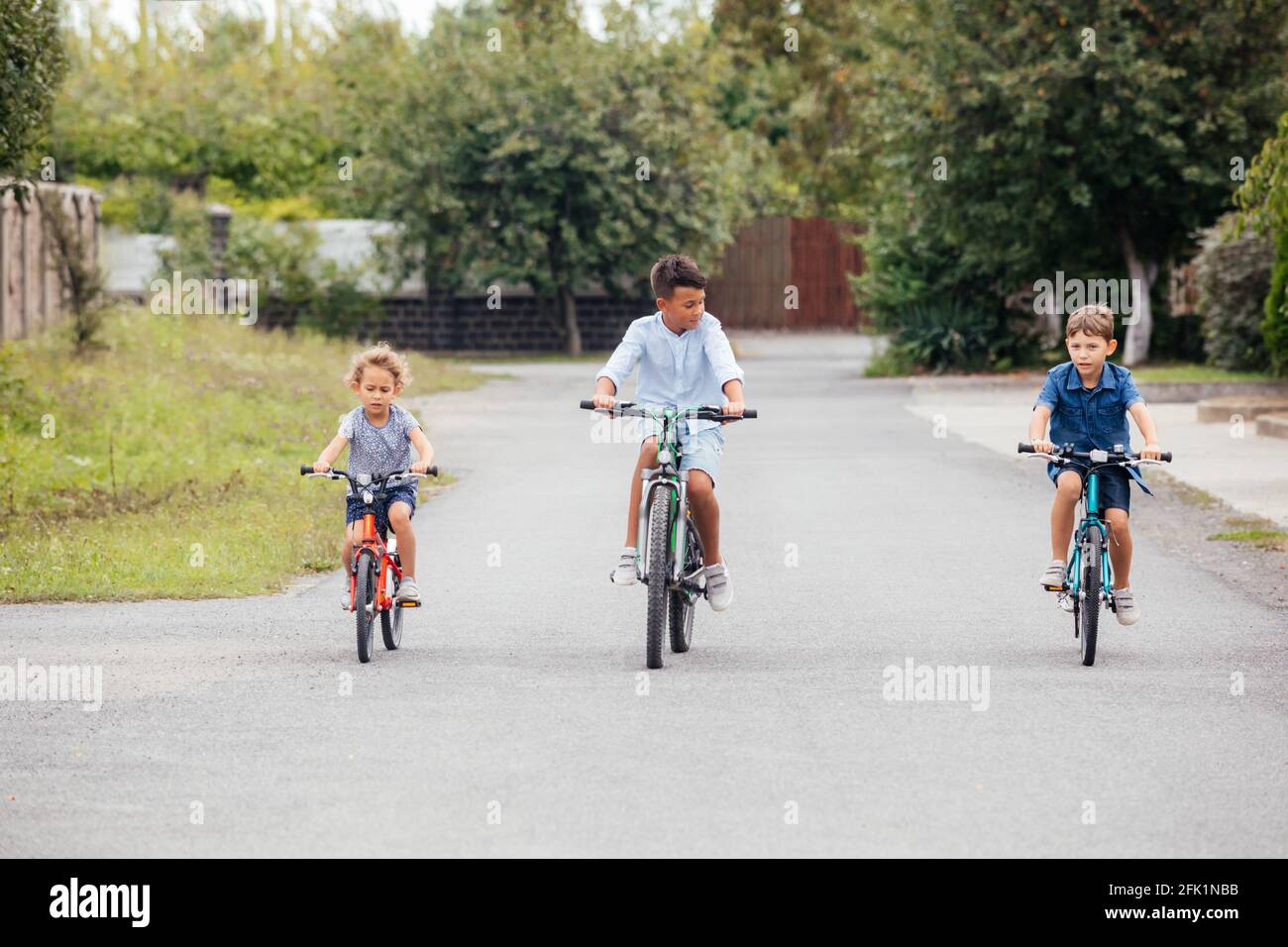 Kids have a leisure on bicycles outoodrs Stock Photo - Alamy