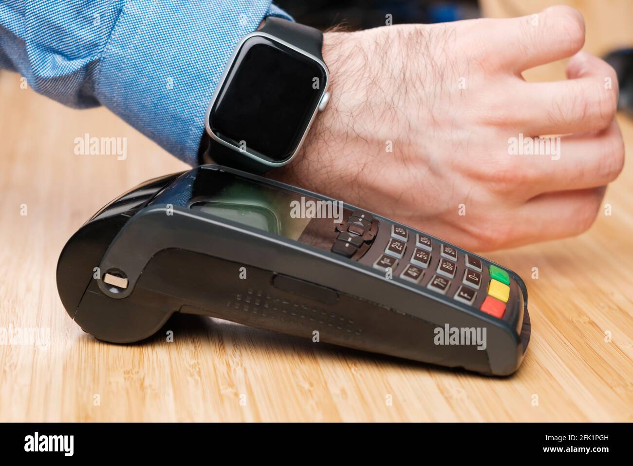 Customer paying through smartwatch using NFC technology. Contactless ...