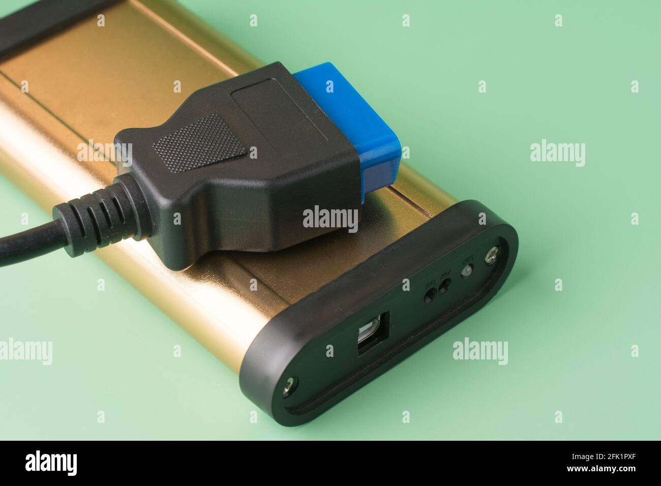 Car diagnostic scanner OBD2 on mint green background. Equipment ...