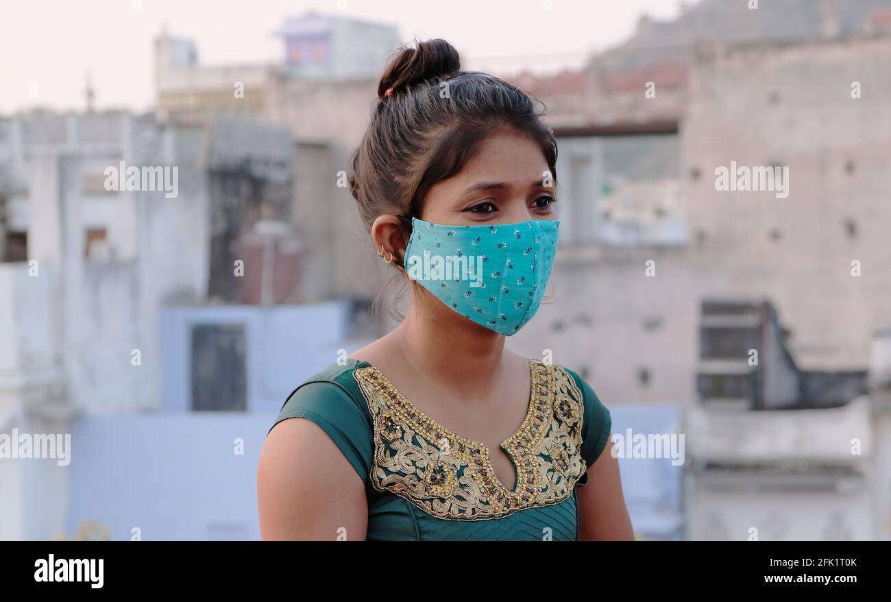 Portrait of a young Indian female wearing a blue textile protective ...