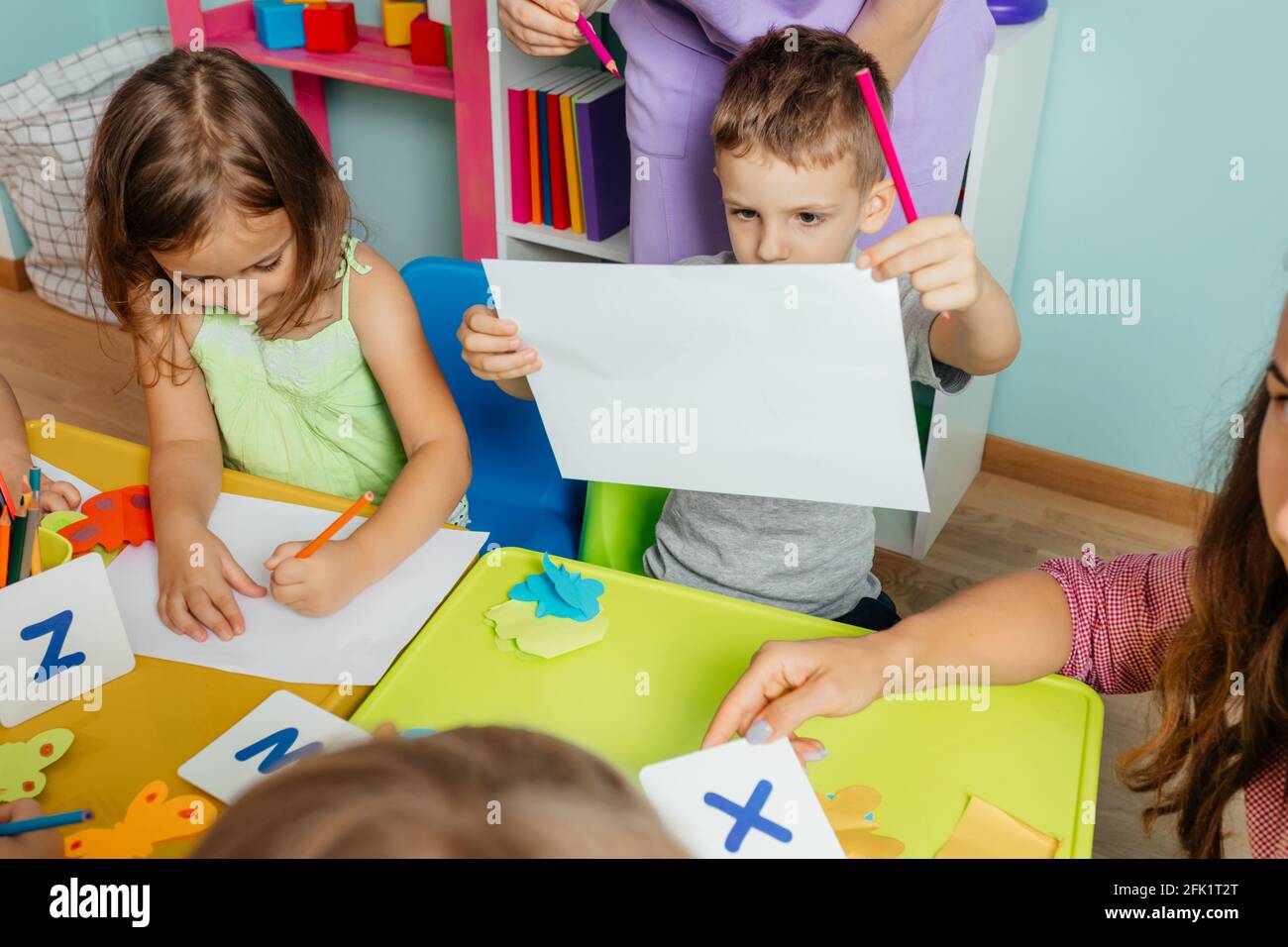 Preschool children learn english alphabet using cards Stock Photo - Alamy