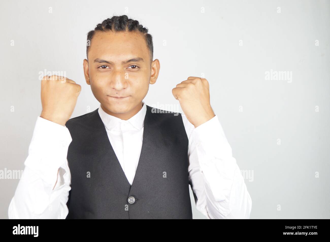 Successful handsome Indian man in formal wear smiling at the camera on ...