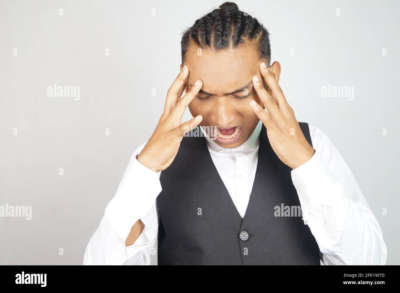 Handsome Indian man in formal wear in shock on a white background Stock ...