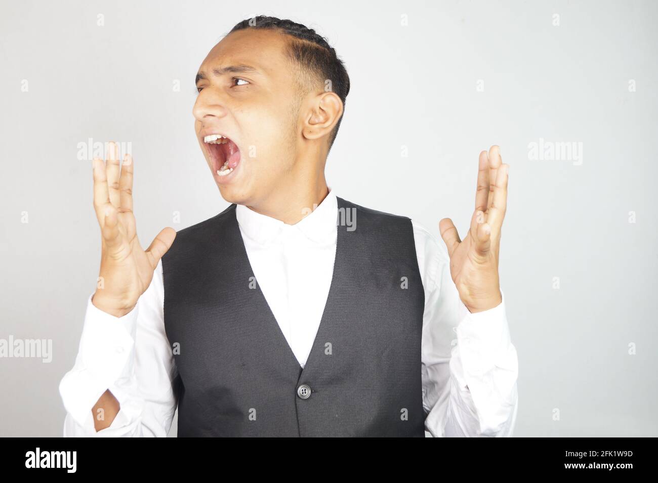 Handsome Indian man in formal wear in shock on a white background Stock ...