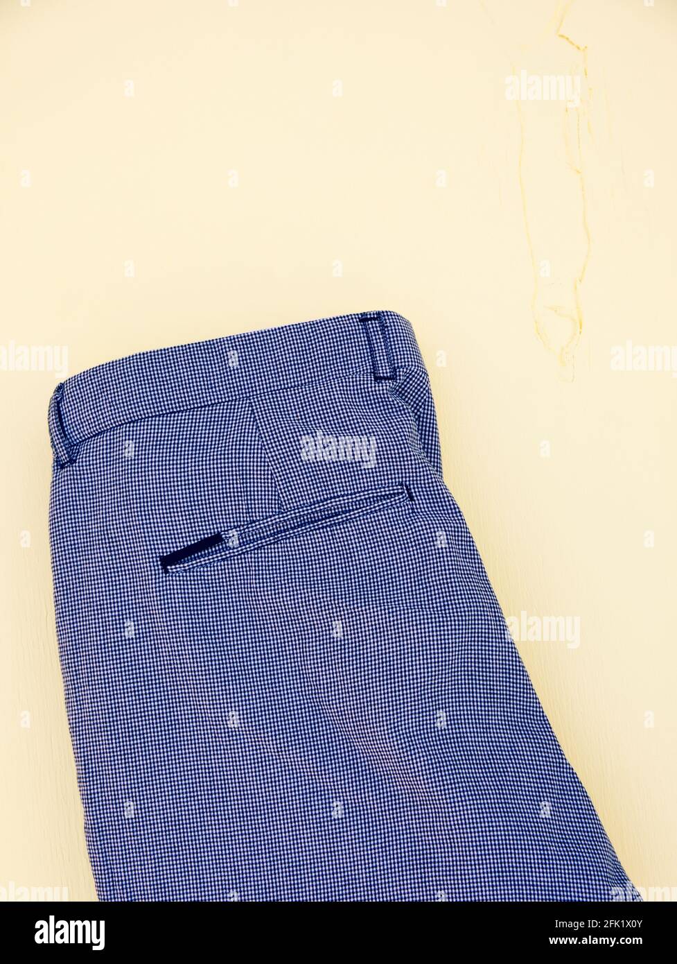Mens checked pattern trousers isolated on yellow background. Concept of ...