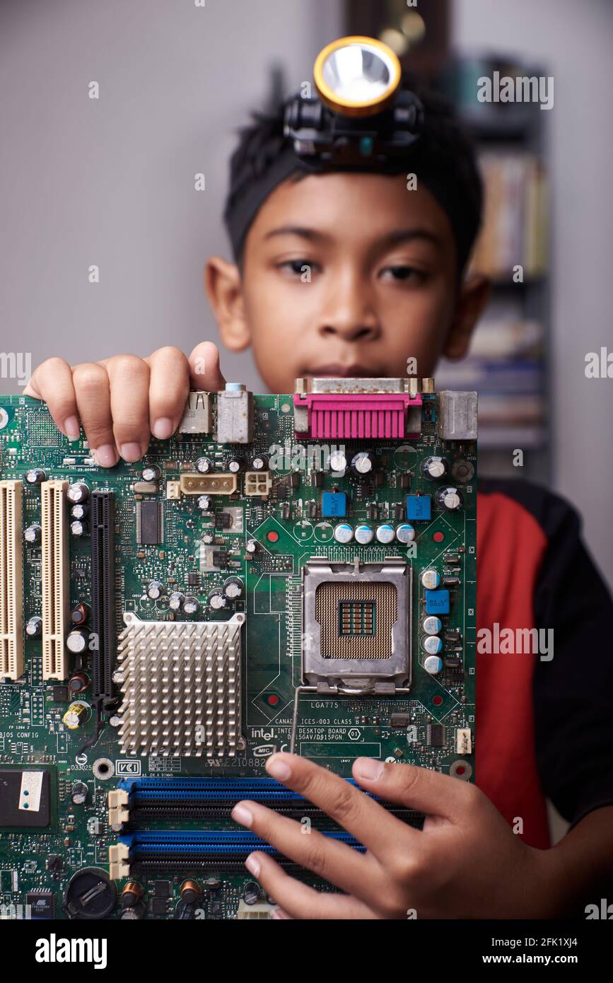 Student boy Studying and repairing Pc motherboard in the Computer Lab ...