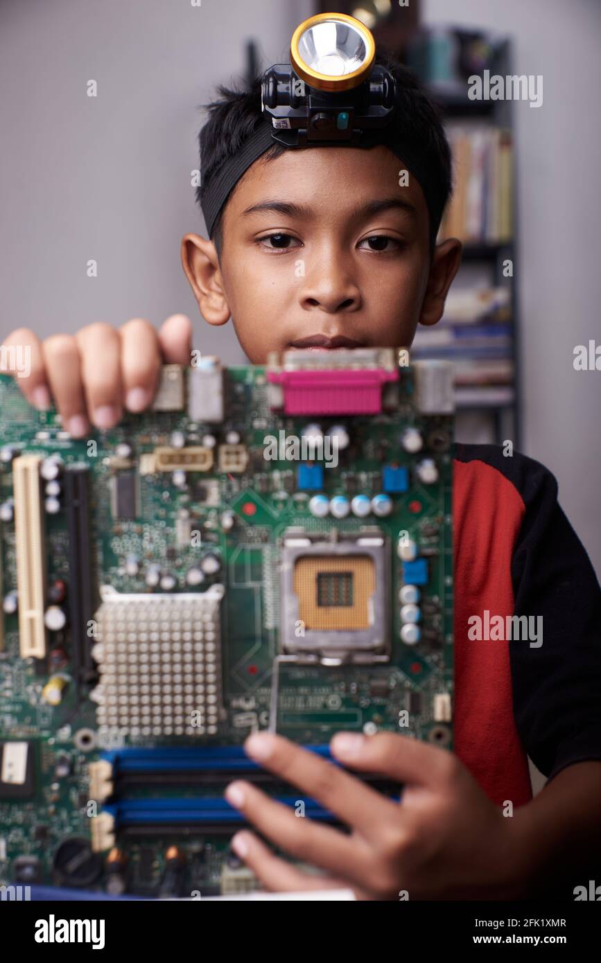Student boy Studying and repairing Pc motherboard in the Computer Lab ...