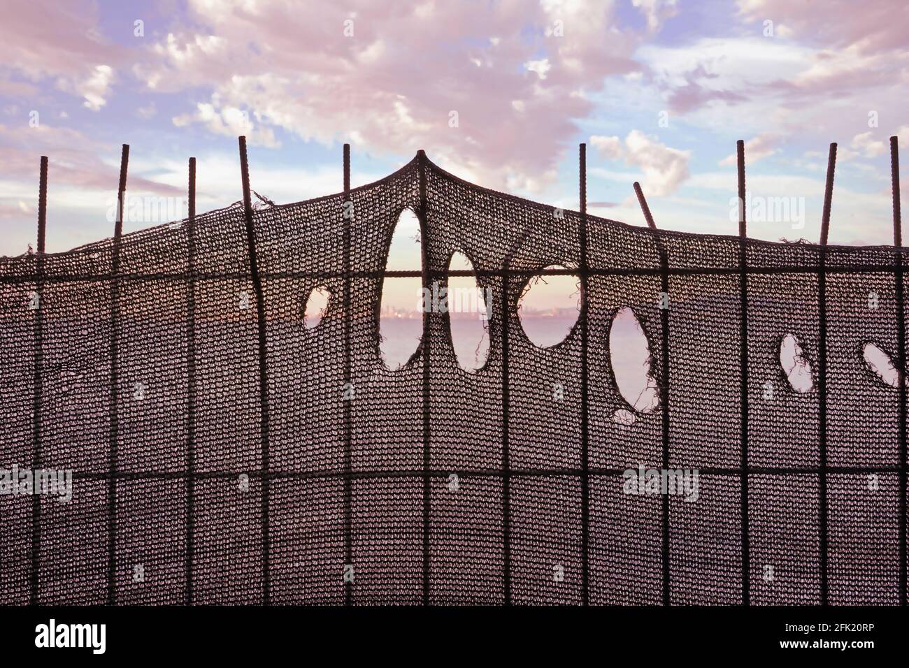 The view from a of stretched net holes. A sea scape and the city at far ...