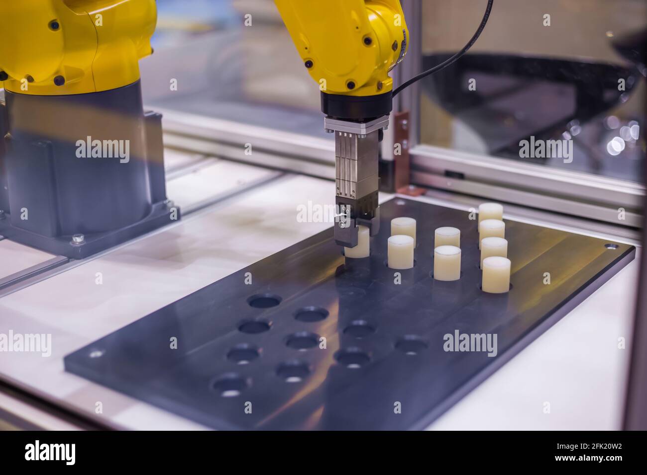 Automated robotic clamp arm moves and places objects at trade show ...